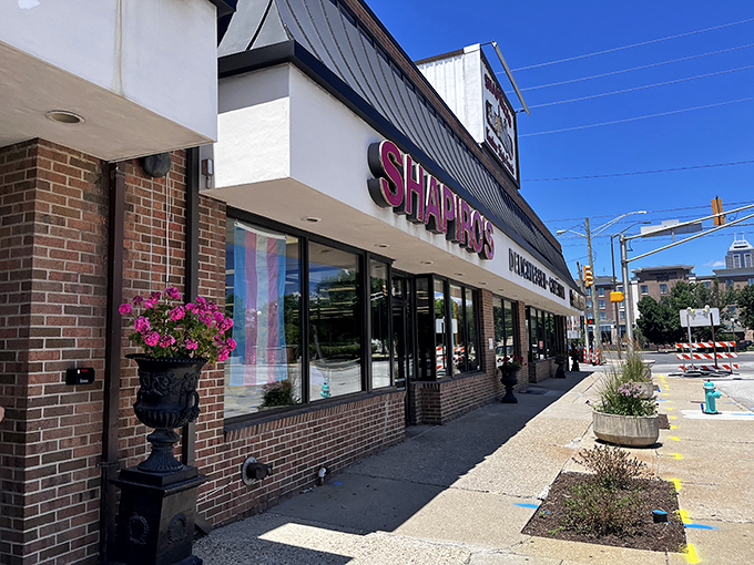 The iconic red Shapiro's sign beckons hungry travelers like a delicatessen lighthouse, promising sandwich salvation to all who enter its doors.