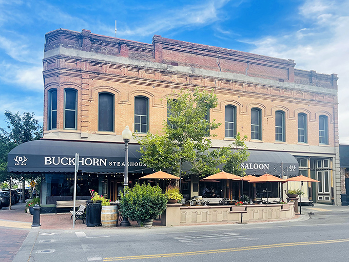 The historic brick fa&ccedil;ade of Buckhorn Steakhouse glows golden at sunset, a beacon of carnivorous delights in downtown Winters that's impossible to resist.