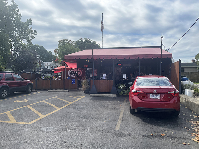 The unassuming red awning and wooden fence might fool you, but locals know this modest exterior hides breakfast treasures worth their weight in maple syrup.