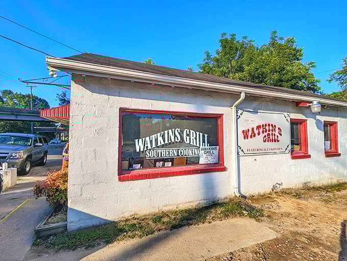 The unassuming white exterior of Watkins Grill stands as a beacon of breakfast hope on Wake Forest Road, where culinary magic happens without fanfare.