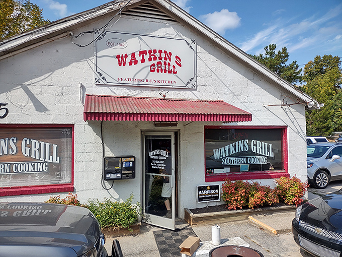 The unassuming white exterior of Watkins Grill stands as a beacon of breakfast hope on Wake Forest Road, where culinary magic happens without fanfare.