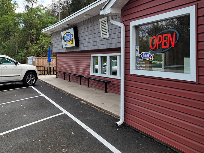 The red siding and glowing "OPEN" sign of Diner 22 isn't just an invitation &ndash; it's a promise of comfort food that awaits within these unassuming walls.