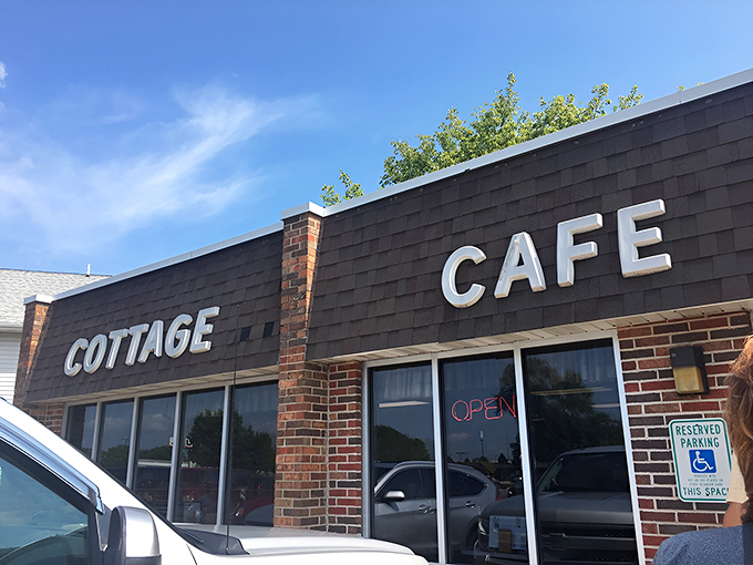The coral-colored awnings of Cottage Cafe stand like beacons of breakfast hope against Madison's skyline, promising comfort food salvation to hungry travelers.