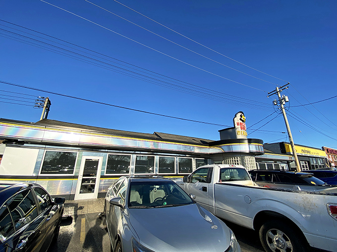 The iconic yellow and black Honey Bee Diner sign stands like a beacon of breakfast hope along Ritchie Highway, promising comfort food salvation to hungry travelers.