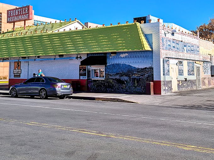 The iconic white and red exterior of Frontier Restaurant stands like a beacon of breakfast hope on Central Avenue, drawing hungry pilgrims daily.