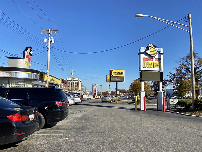 The iconic yellow and black Honey Bee Diner sign stands like a beacon of breakfast hope along Ritchie Highway, promising comfort food salvation to hungry travelers.