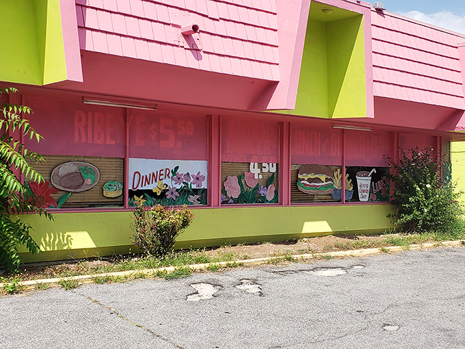 The pink and lime green exterior isn't trying to blend in—it's shouting "come hungry, leave happy" with all the subtlety of a breakfast-loving flamingo.