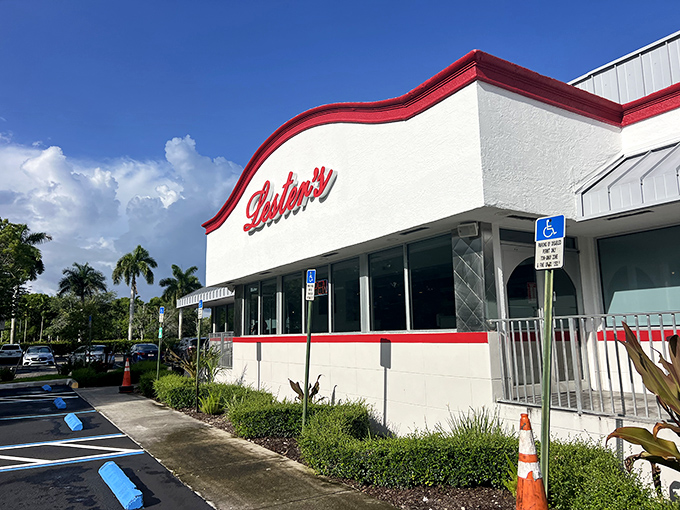 The iconic red and white exterior of Lester's Diner stands like a time capsule of Americana, beckoning hungry travelers with promises of comfort food paradise.