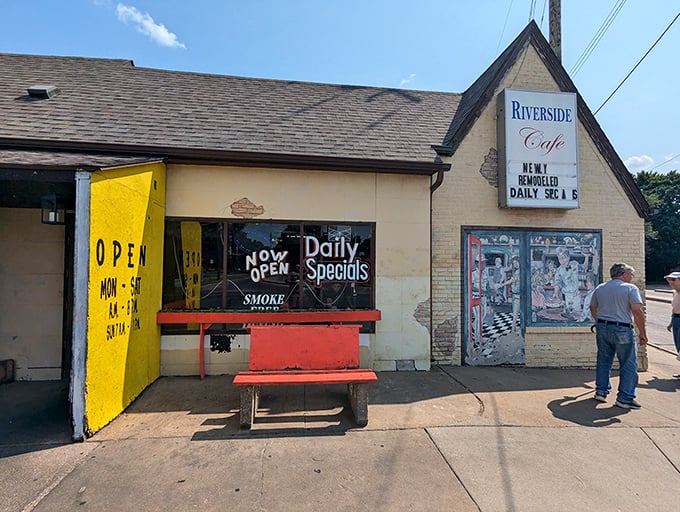 The unassuming A-frame exterior of Riverside Cafe stands like a time capsule, complete with a hand-painted mural promising culinary treasures within.