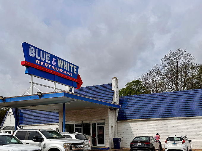 The iconic Blue & White Restaurant stands as a time capsule of Americana, its vintage gas station canopy beckoning hungry travelers along Highway 61.