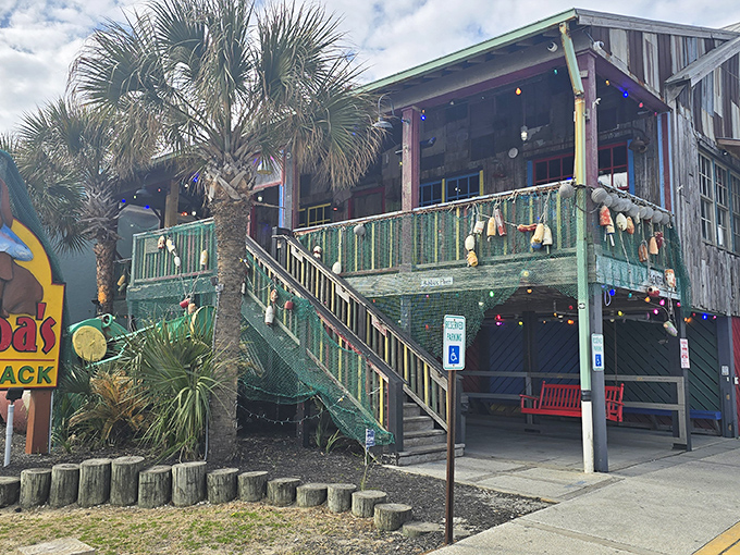 The weathered wooden exterior of Bubba's Fish Shack stands proudly against the Carolina blue sky, promising seafood treasures within those rustic walls.