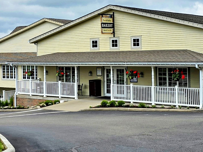 The white clapboard facade of Dutch Valley Restaurant welcomes hungry travelers like a warm hug, complete with inviting porch and hanging flower baskets.