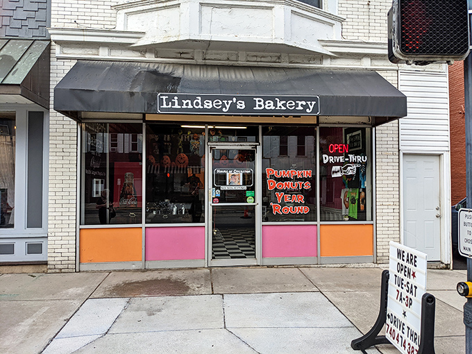 The unassuming storefront of Lindsey's Bakery beckons with its vintage charm and colorful panels. Donut paradise awaits behind that glass door.