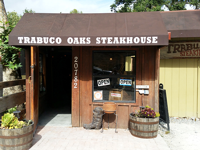 The unassuming entrance to carnivore paradise. Wooden barrels bursting with flowers welcome you to a place where neckties fear to tread.