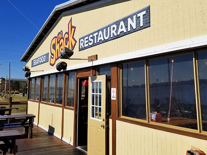 The unassuming yellow exterior of The Shack stands like a beacon of culinary promise on Fort Walton Beach's coastline. No pretense, just seafood perfection awaiting inside.