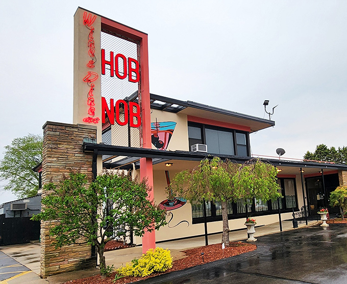 That iconic red neon sign beckons like an old friend, promising a night of culinary nostalgia and Midwest hospitality at HOBNOB Restaurant.
