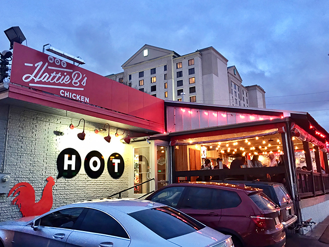 The iconic red script against white beckons like a siren song to heat-seekers. This Nashville landmark promises pleasure and pain in equal measure.