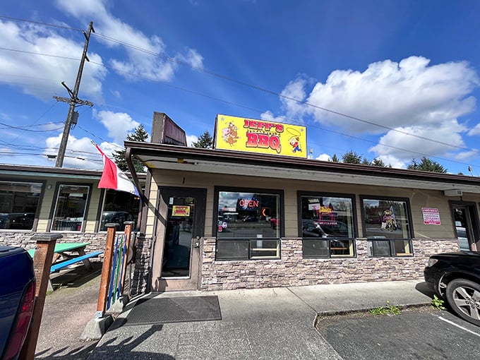 The bright yellow sign of Jeff's Texas Style BBQ beckons hungry travelers like a smoky lighthouse guiding ships through fog.