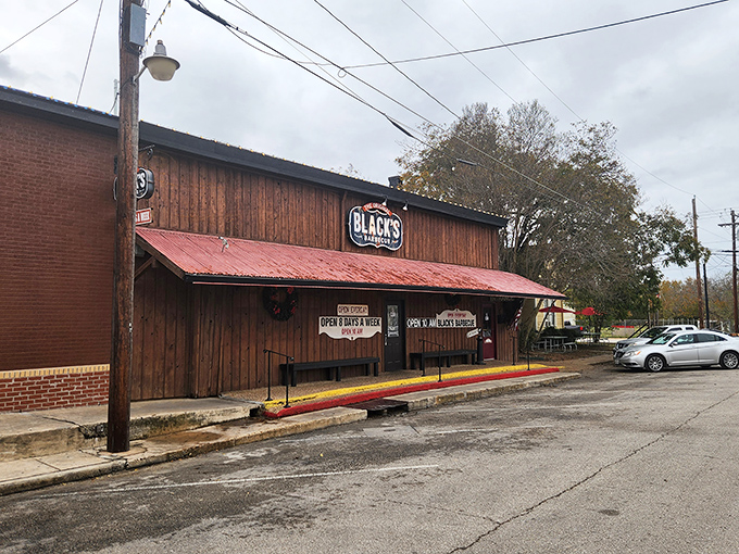 The wooden facade with its weathered red roof and patriotic bunting isn't just announcing "Texas"&mdash;it's practically singing the state anthem while waving a Lone Star flag.