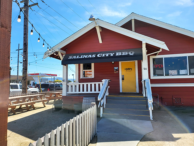 The little red house with the bright yellow door isn't trying to impress anyone&mdash;until you taste what's coming out of those smokers.