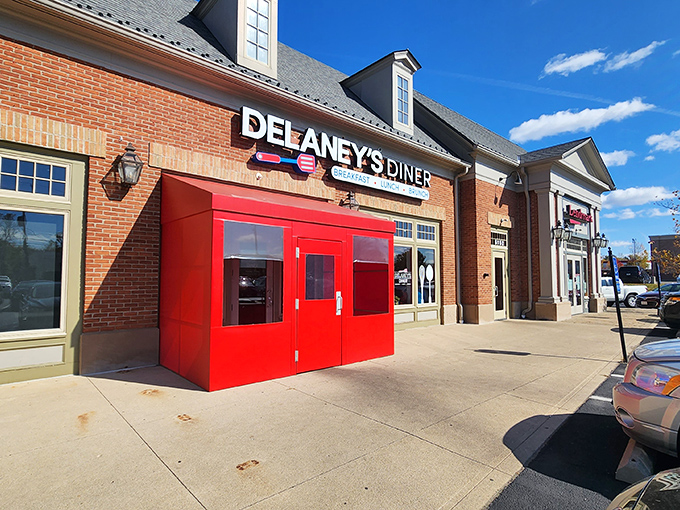 The brick facade and bright red doors of Delaney's Diner stand like a beacon of breakfast hope on East Main Street in Columbus.