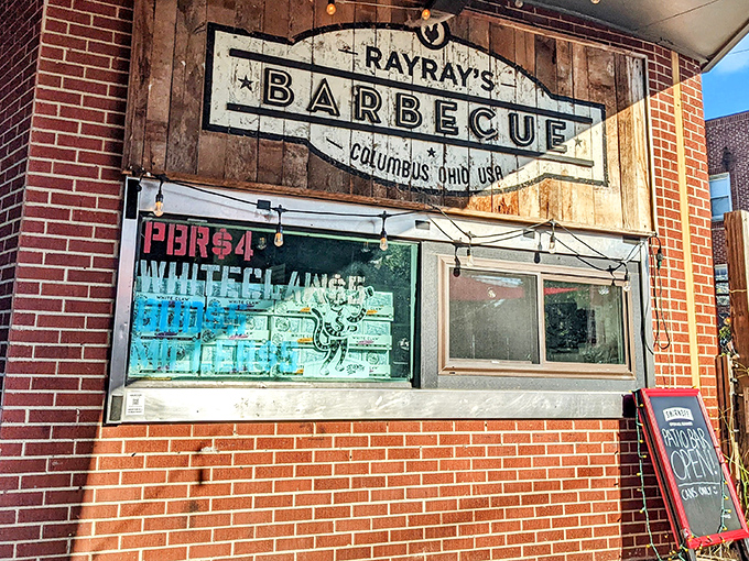The weathered wooden sign at Ray Ray's speaks volumes: serious barbecue happens here, no frills necessary, just pure smoky perfection.