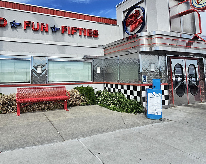 The gleaming chrome exterior of Dixie's Diner shines like a beacon of hope for hungry travelers, its classic checkerboard trim promising authentic American comfort food inside.