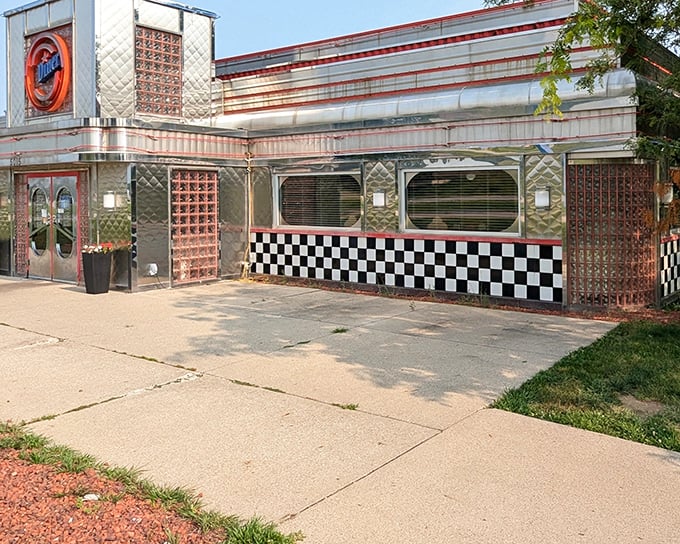 The gleaming stainless steel exterior with classic checkered trim promises a time-traveling culinary adventure before you even step inside.