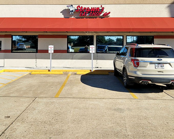 The unassuming red awning of Strawn's Eat Shop Too stands like a beacon to hungry travelers. No fancy frills needed when the food inside speaks volumes.