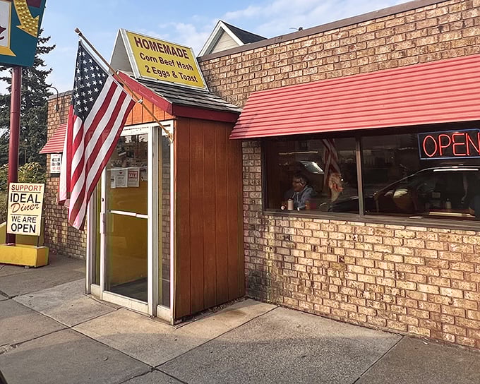 A humble brick fortress with an American flag standing guard, protecting the culinary treasures that await inside.