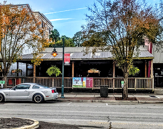 The welcoming front porch at Pawleys beckons like an old friend, promising cold drinks and burger bliss in Columbia's Five Points district.