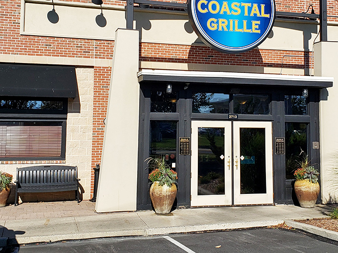 The blue sign beckons like a lighthouse for hungry travelers. Coastal Grille's welcoming entrance promises seafood salvation in suburban Wyomissing.