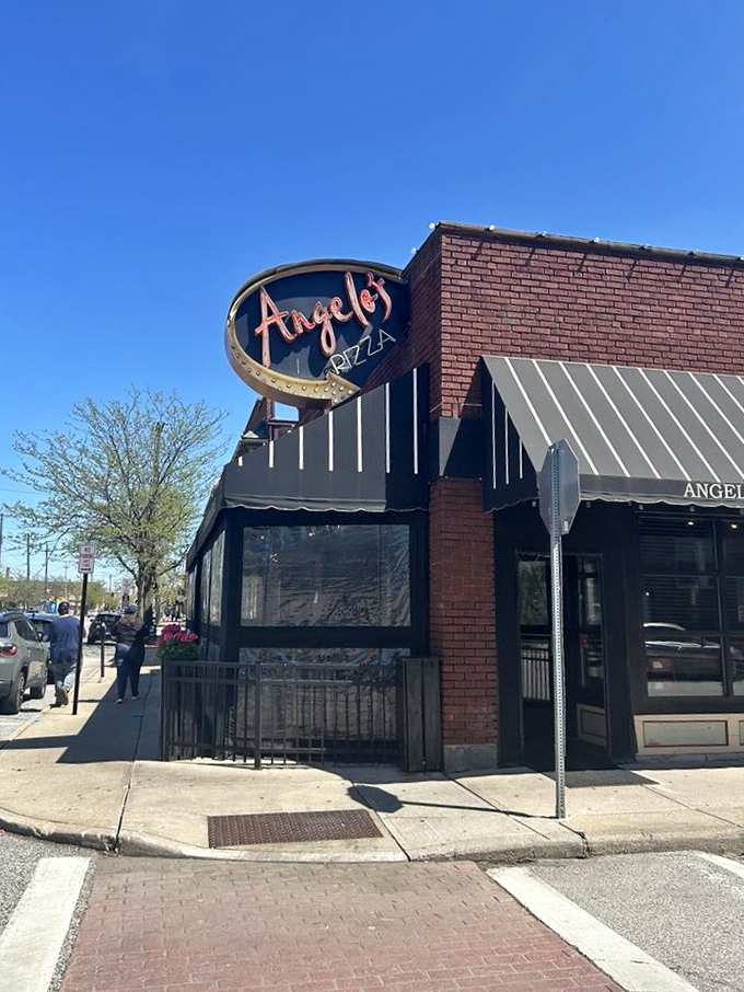 The unassuming brick fa&ccedil;ade of Angelo's Pizza hides culinary treasures within. Like a superhero's secret identity, it's modest on the outside, magnificent on the inside.