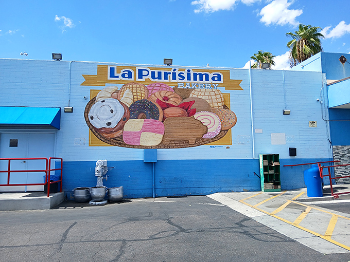 The blue and white exterior of La Purisima stands like a desert oasis, promising authentic Mexican flavors beneath the watchful Arizona palms.