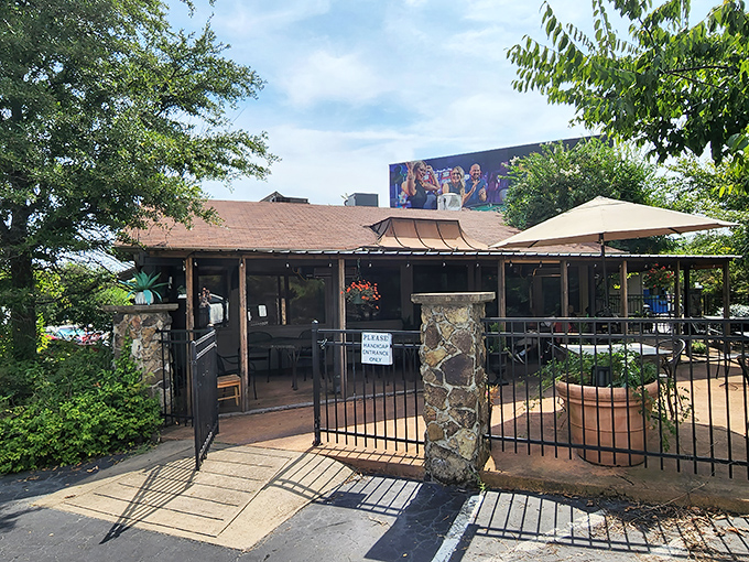 Welcome to culinary paradise! The charming exterior of Red Door, with its signature red trim and inviting wooden staircase, promises delicious adventures within.