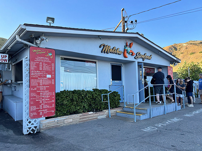 The unassuming white building with its cheerful red trim might not scream "culinary destination," but locals know this seafood shack holds treasures that would make Neptune himself line up.