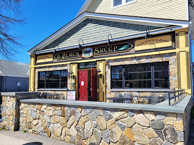 The stone facade and iconic red doors of The Black Sheep stand like a culinary lighthouse on Niantic's shore, beckoning hungry travelers with promises of exceptional fare.