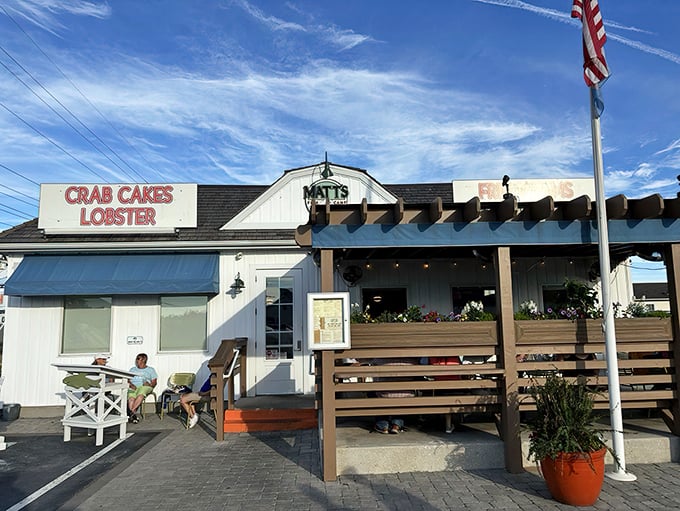 A coastal dream come true! Matt's Fish Camp's charming exterior with its blue accents, vibrant flower boxes, and inviting pergola practically whispers "come in, the seafood's fantastic."