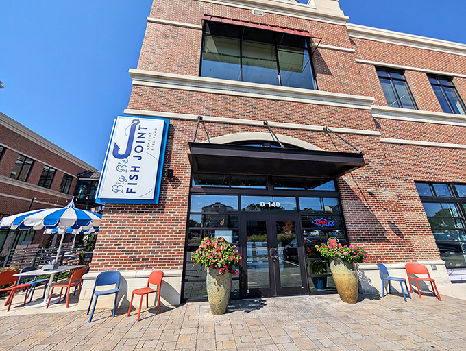 The brick fa&ccedil;ade of Big B's Fish Joint welcomes seafood lovers with its distinctive blue and white signage and inviting patio umbrellas.
