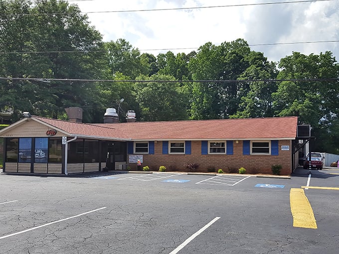 Unassuming culinary treasures often hide in plain sight. This modest brick building in Dallas, NC houses seafood magic that would make coastal restaurants envious.