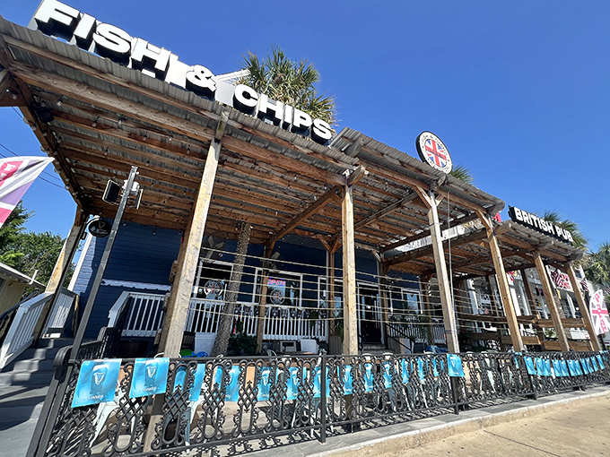 The blue facade of Fish and Chips Houston stands proudly in Kemah, where palm trees and Union Jacks create the most delightful cultural collision since tea met Texas.