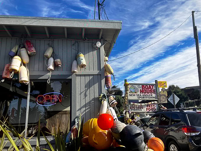 Maritime charm meets culinary treasure at The Boat House's exterior, where colorful buoys and fishing floats hint at the ocean-fresh delights waiting inside.