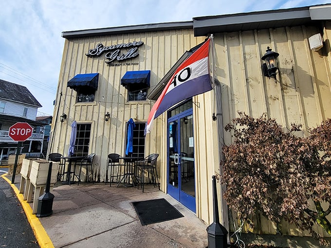 The iconic tan exterior with blue accents and welcoming patio whispers "come inside" like a culinary siren song.