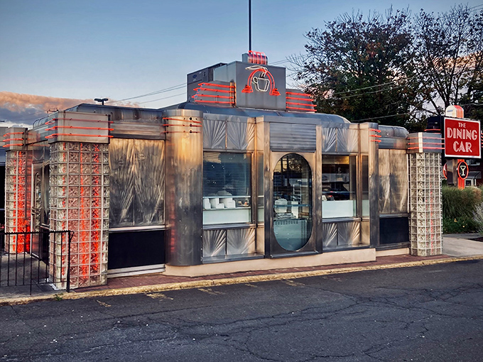 Gleaming in the sunset glow, The Dining Car's classic stainless steel exterior promises a time-traveling culinary adventure that begins before you even step inside.