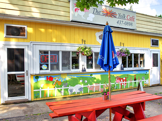 The sunshine-yellow exterior of The Yolk Cafe practically screams "happiness served here!" Those playful monkey silhouettes add a touch of whimsy to your breakfast adventure.