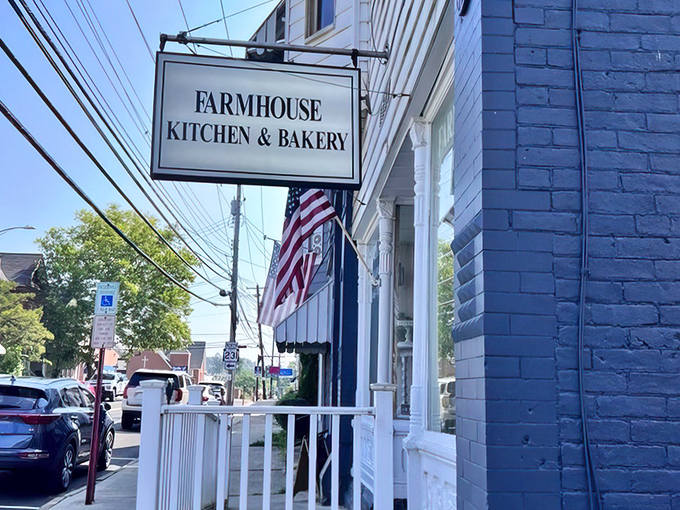 The classic American flag waves proudly outside this charming white storefront, where breakfast dreams come true and calories don't count until tomorrow.