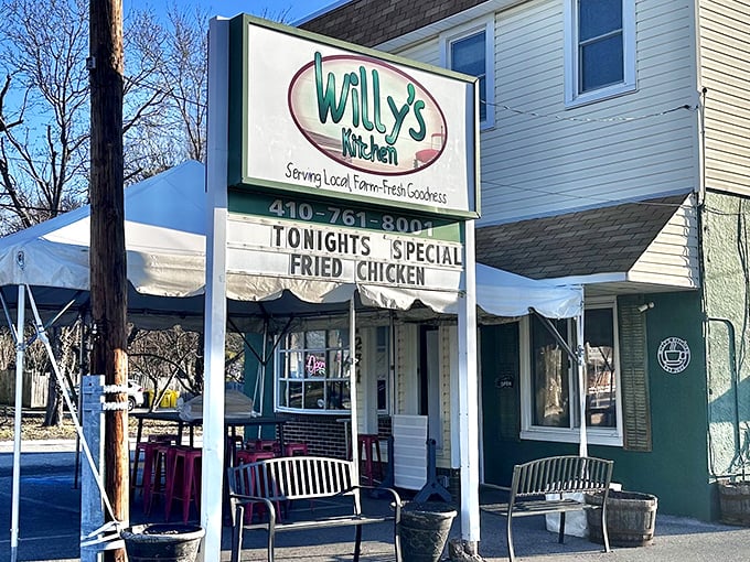 The unassuming exterior of Willy's Kitchen proves once again that the best food often hides behind the most modest facades. That sign promises fried chicken glory!