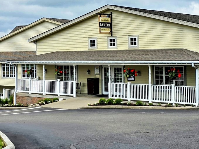 The white clapboard facade of Dutch Valley Restaurant welcomes hungry travelers like a warm hug, complete with inviting porch and hanging flower baskets.
