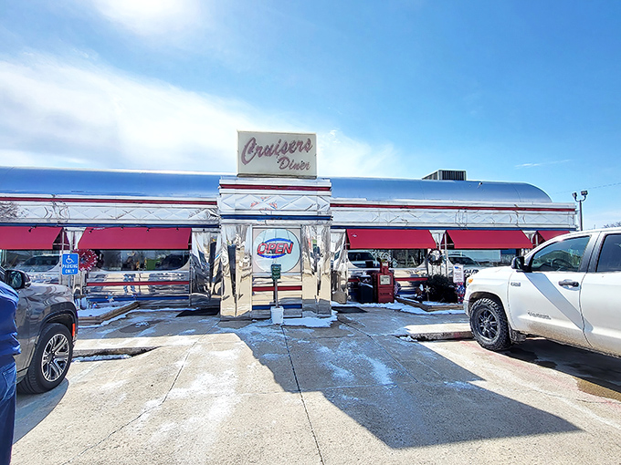 The gleaming stainless steel exterior of Cruisers Diner shines like a beacon of hope for hungry travelers. This chrome time capsule promises delicious nostalgia inside. 