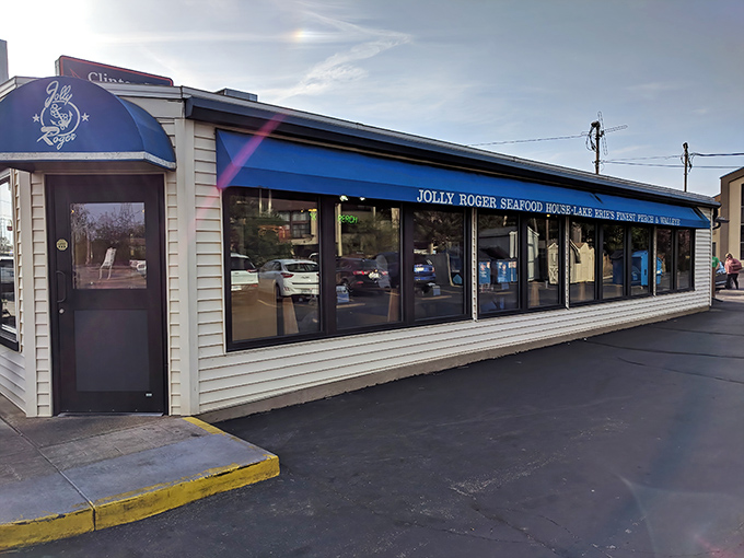 The unassuming exterior of Jolly Rogers beckons like a lighthouse to hungry travelers. Those red umbrellas promise summer delights regardless of the season.